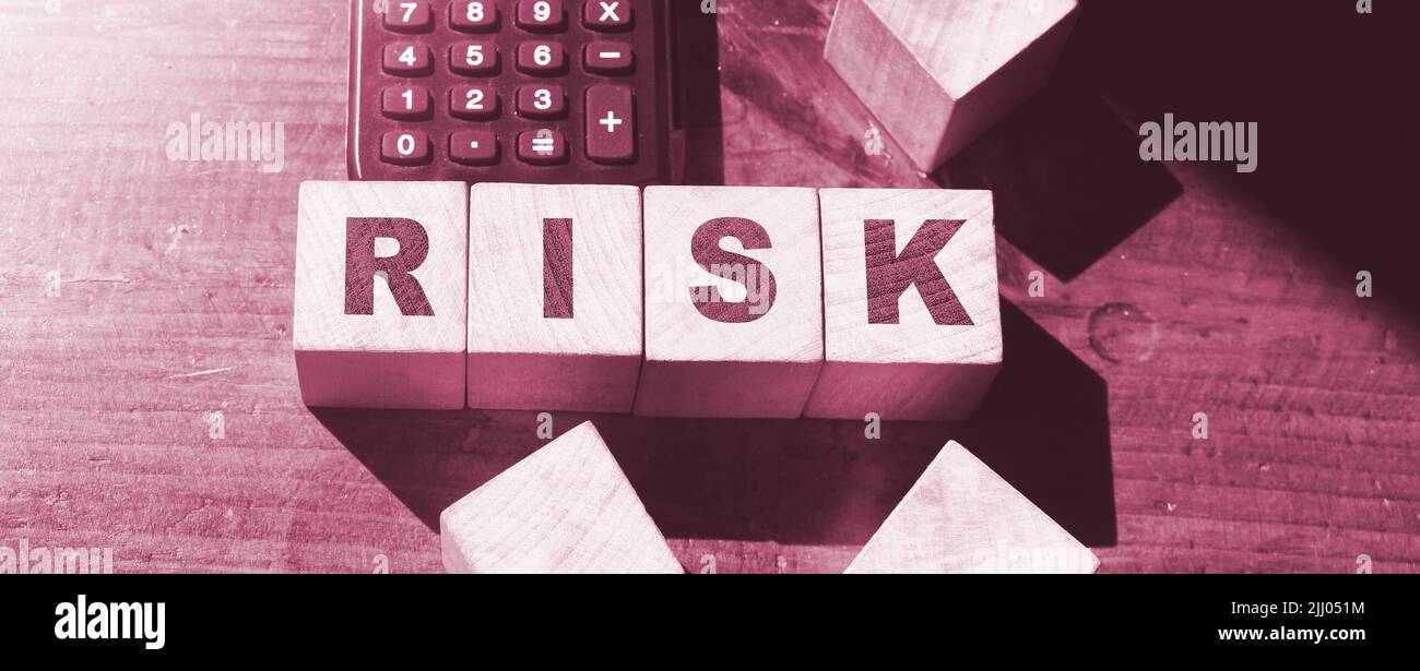 RISK word written on wooden cubes and calculator. Financial risk ...
