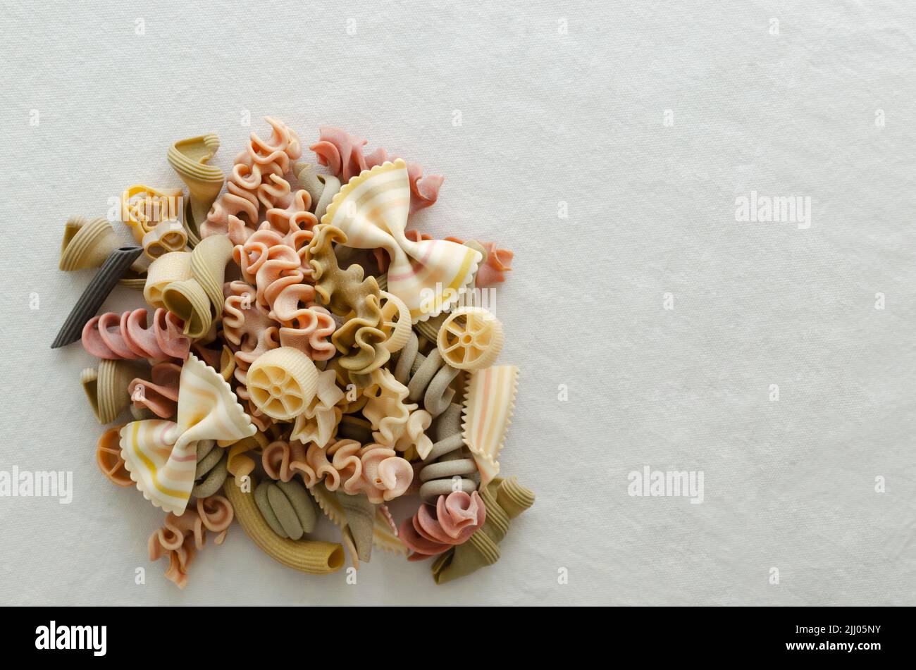 Mix of multi-colored Italian pasta on a light background. Concept ...