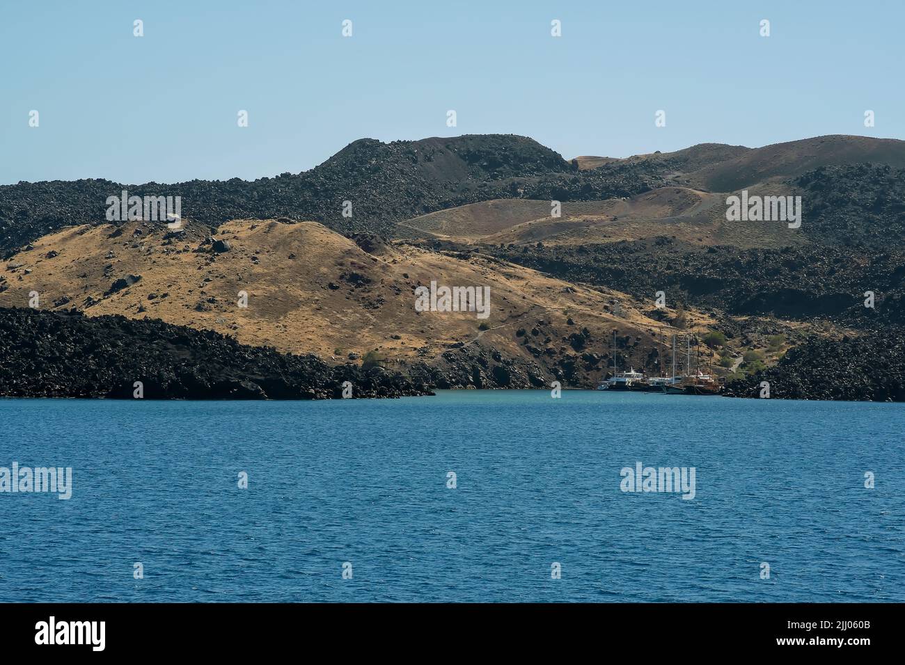 Close up view of the island of volcanic origin, Nea Kameni, that has ...