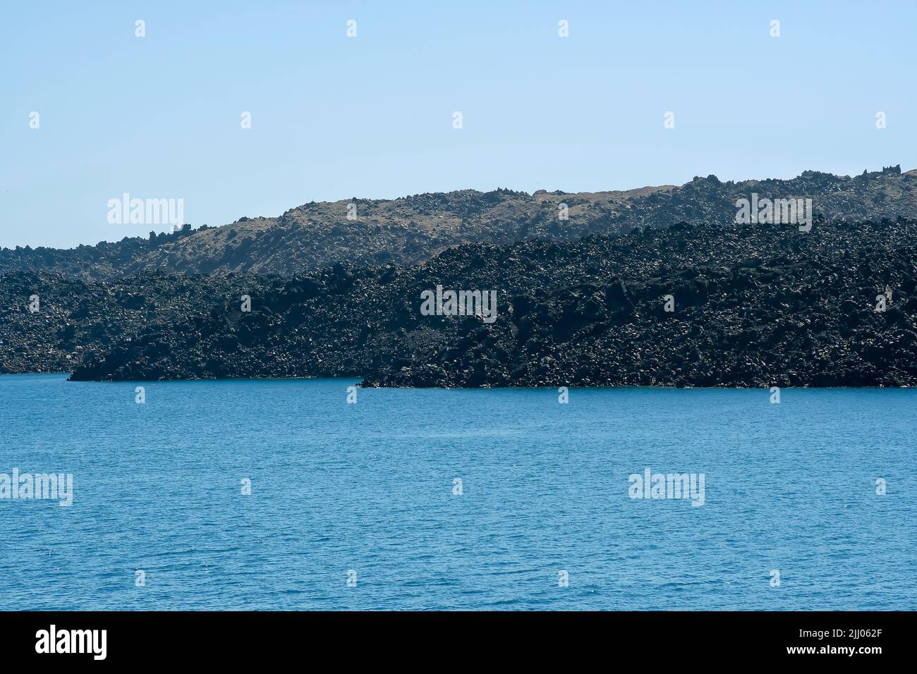 Close up view of the island of volcanic origin, Nea Kameni, that has ...