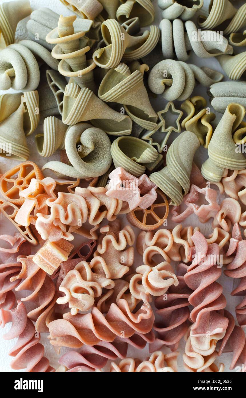 Background Mix of multi-colored Italian pasta on a light background ...