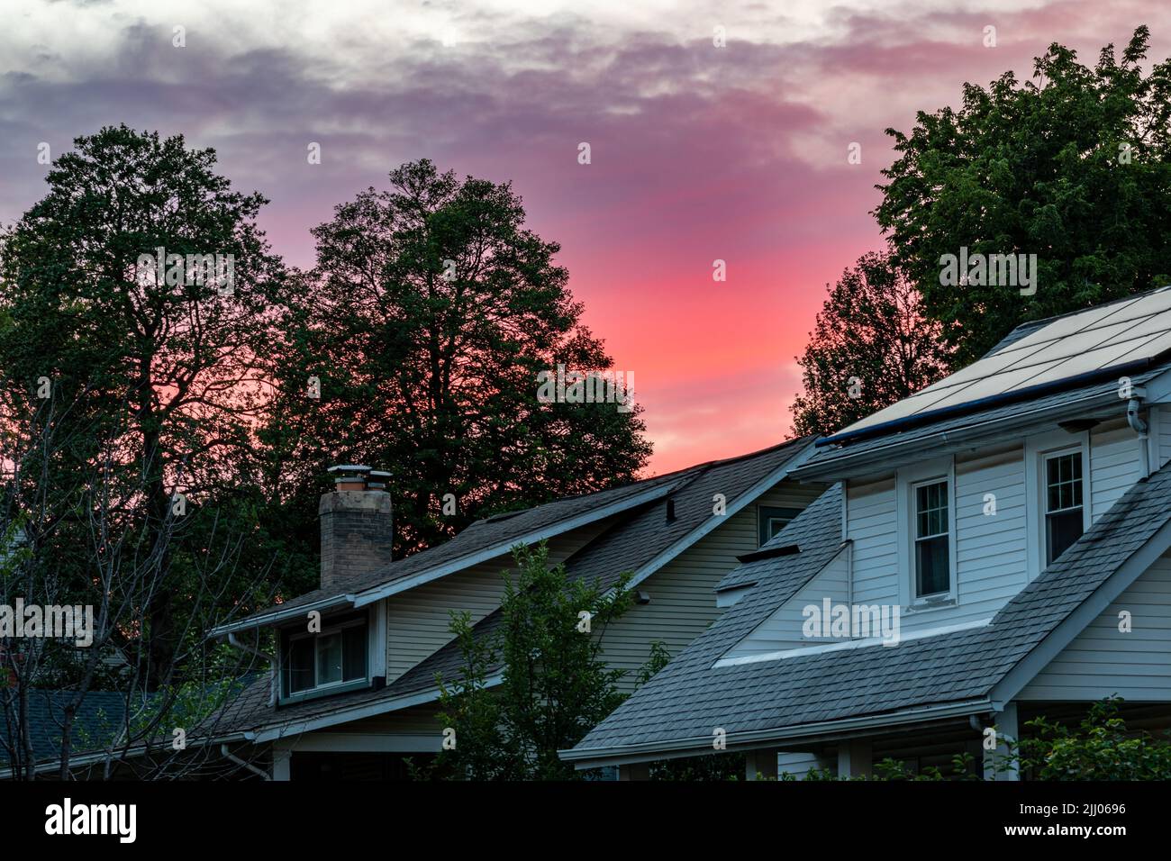 Colorful sunset sky behind suburban Washington, DC rooftops Stock Photo ...