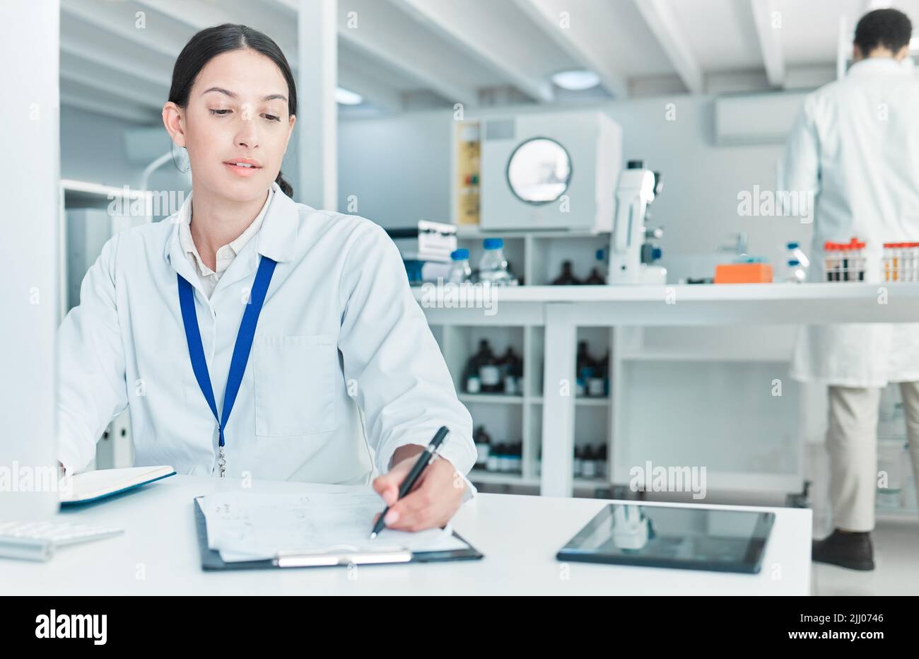 Establishing reliable facts. a young scientist writing notes while ...