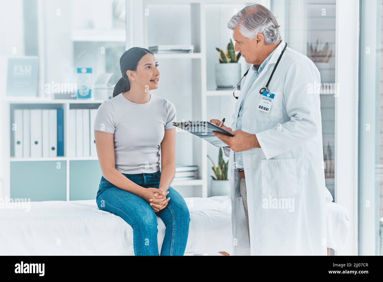 Is your information up to date. a doctor recording a patients ...