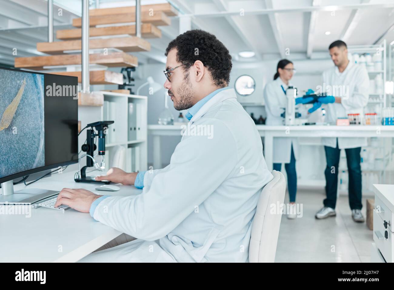 Checking over the facts multiple times. a young scientist using a ...
