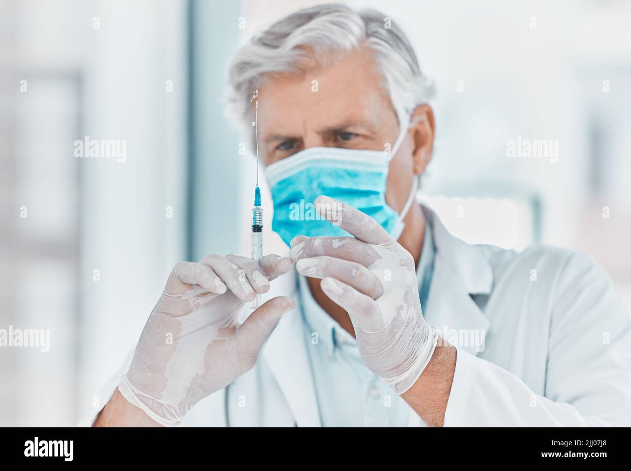 keeping his patients safe. a doctor preparing to administer an ...