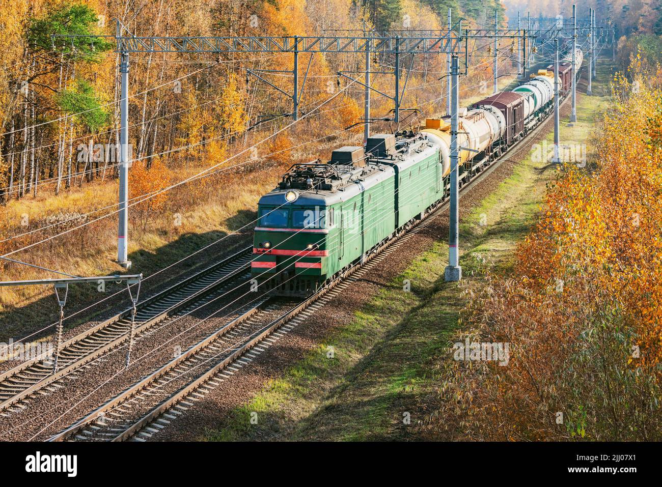 Freight train approaches to the station at autumn day Stock Photo - Alamy