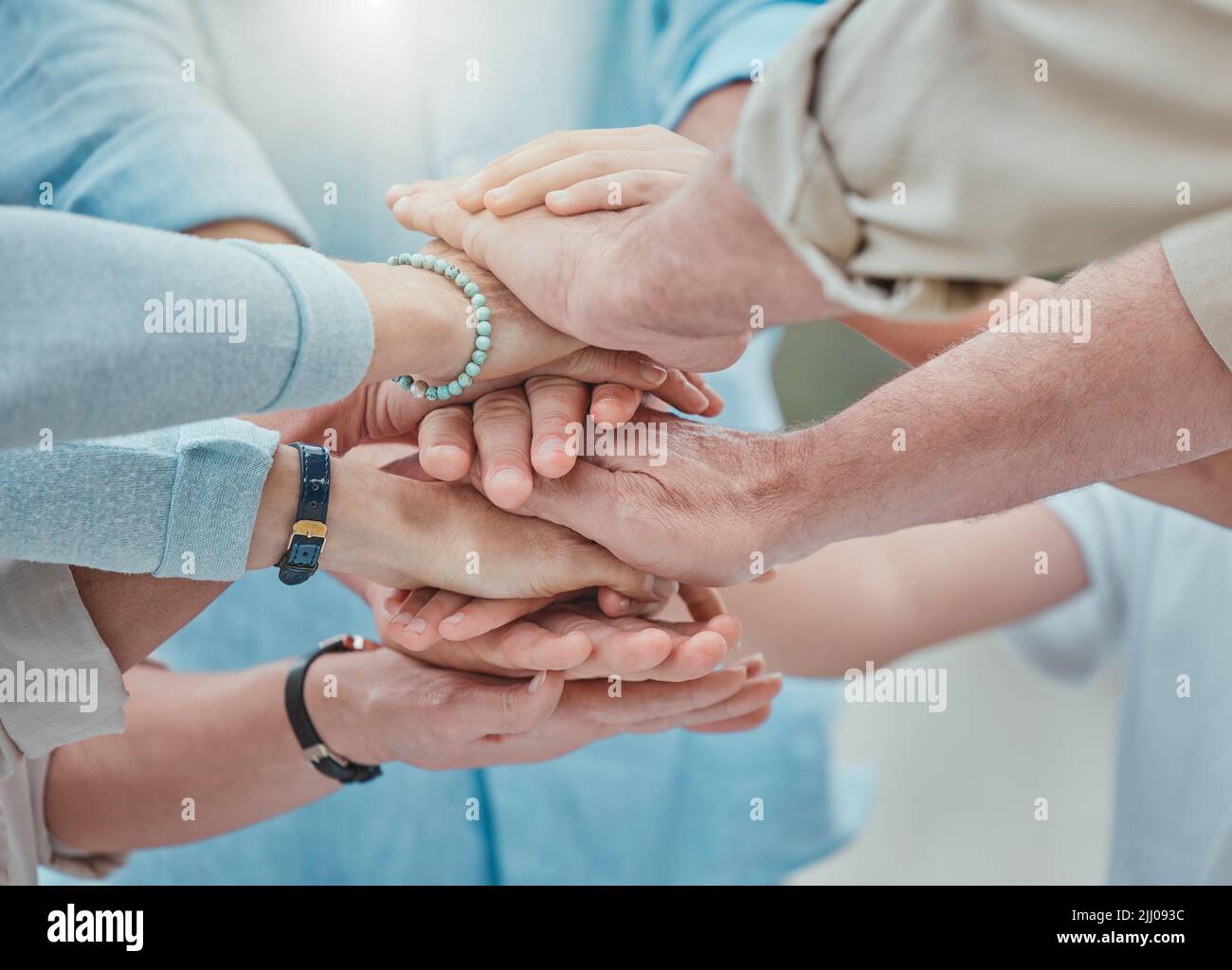 Blessed with the best team. a family stacking their hands in the garden ...