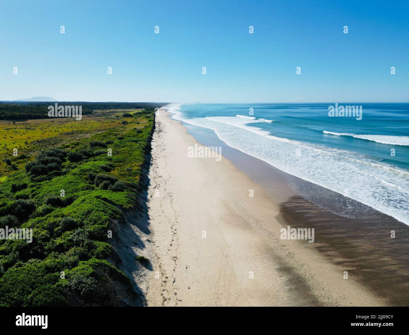 The wavy beach line in Australia on a sunny day Stock Photo - Alamy