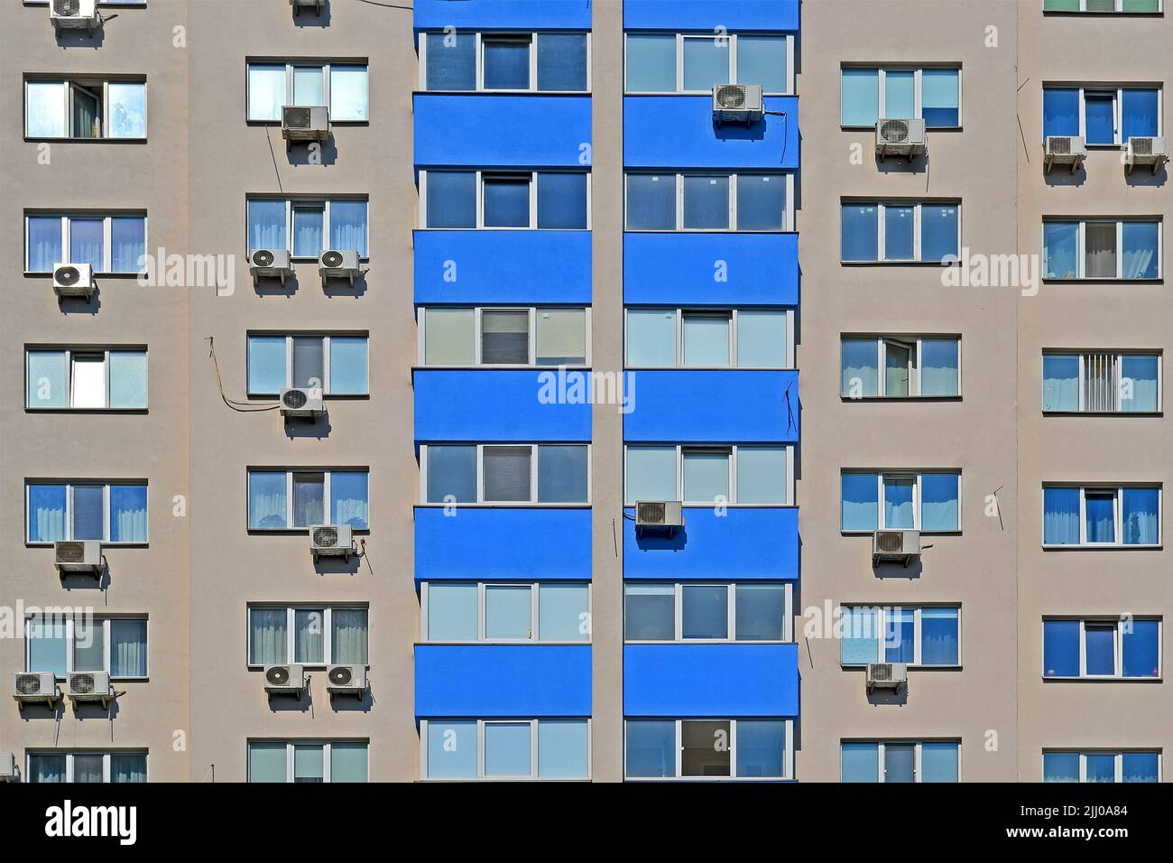 modern building wall with blue balcony line and glass windows, real ...