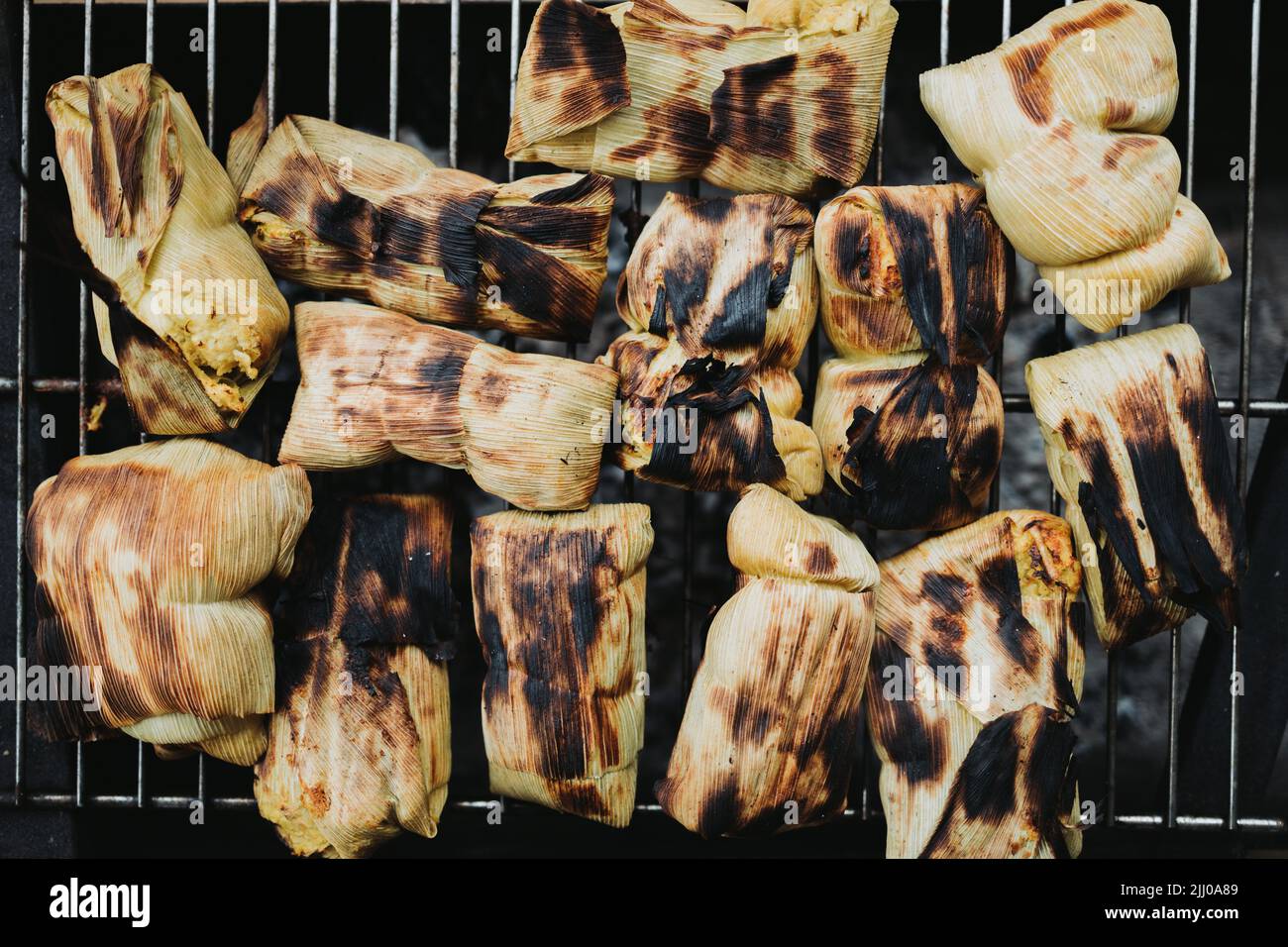 toasted homemade chilean humitas on the grill. Ground corn mix wrapped ...