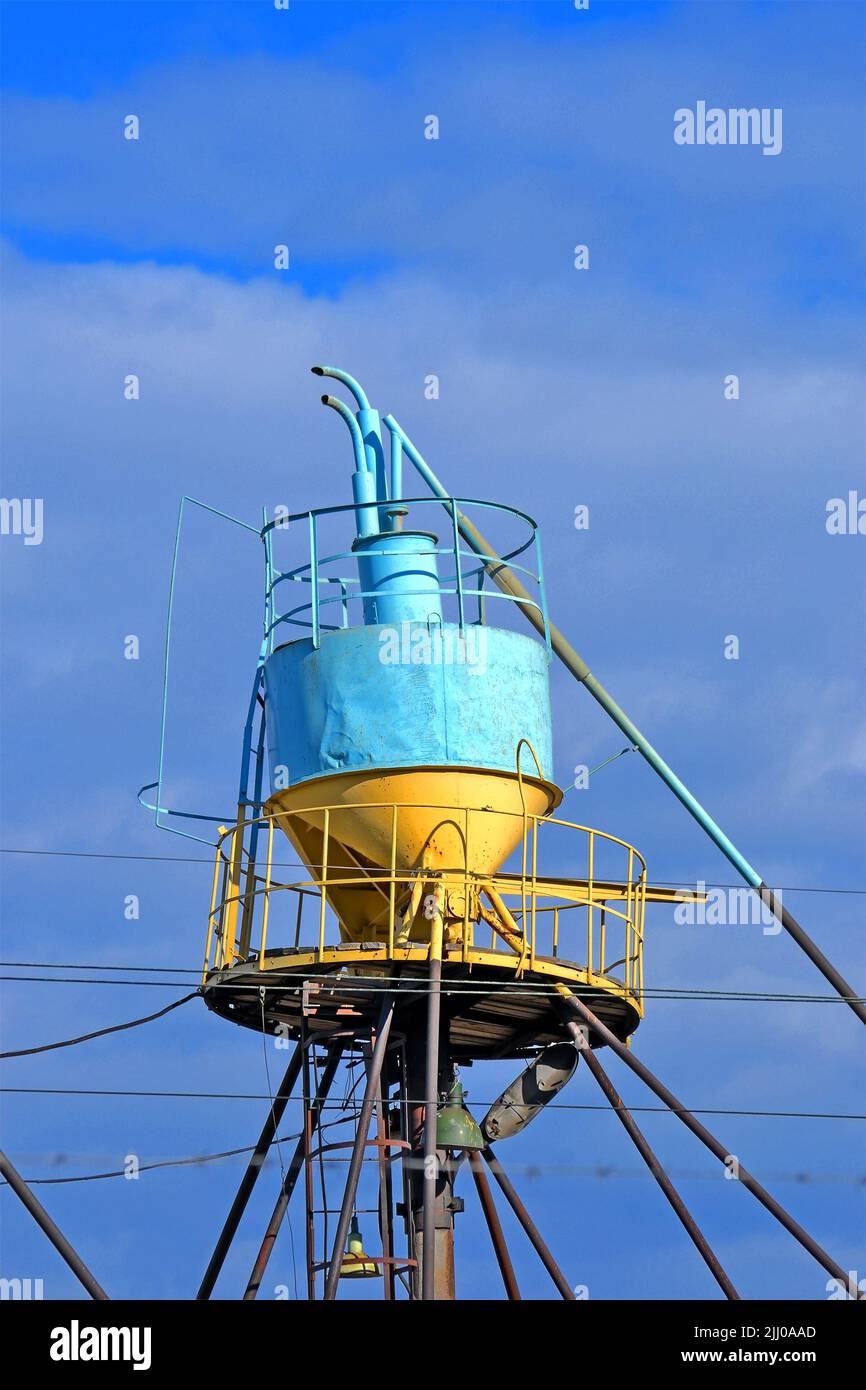large color grain bin bunker (dispenser and dryer) behind the wires at ...