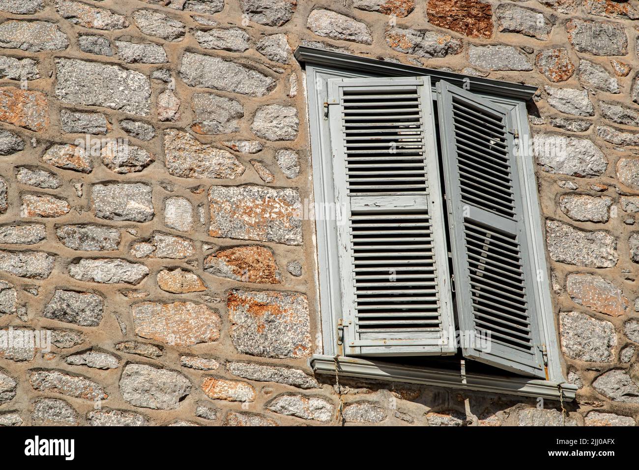 Wooden window shutters on old stone house closeup Stock Photo - Alamy