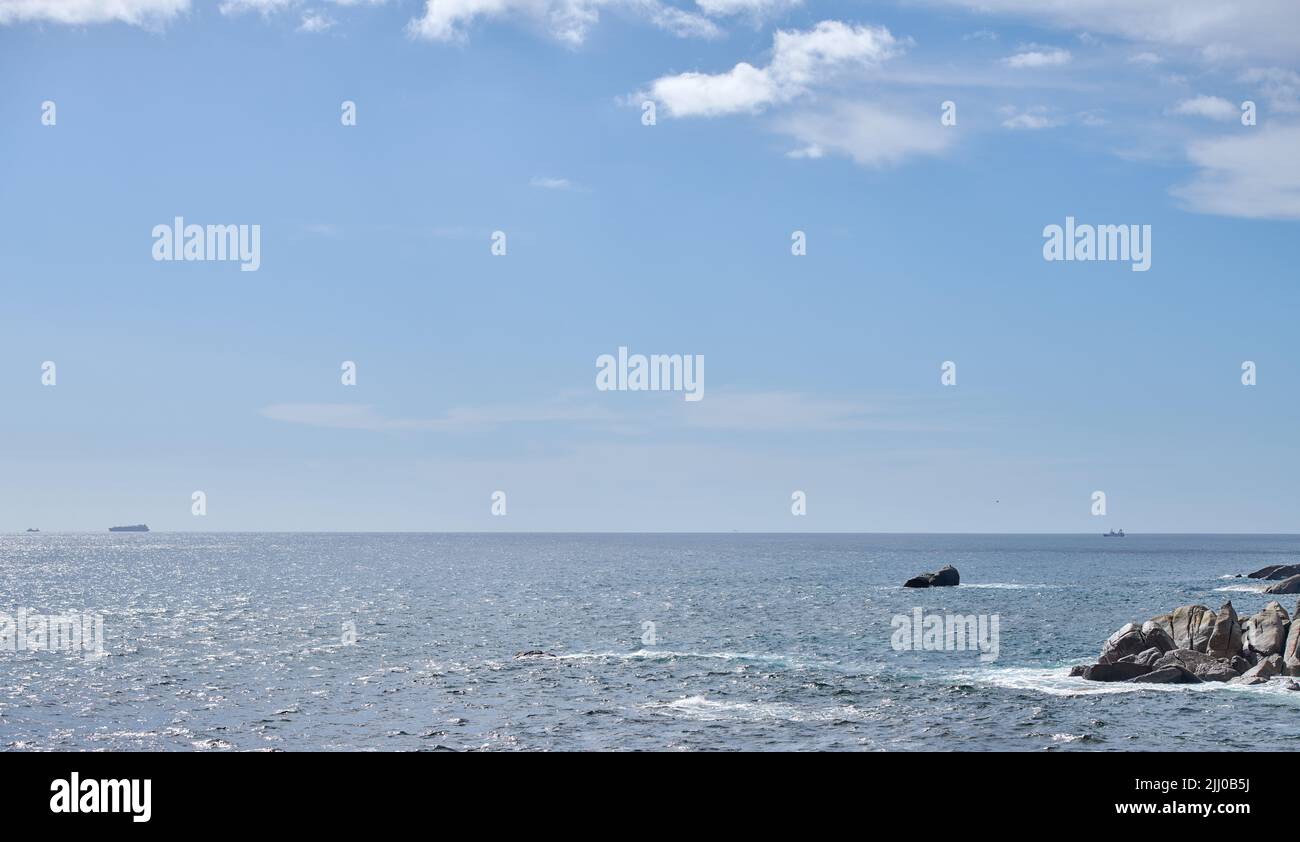 Copy space at the sea with a cloudy blue sky background above the ...