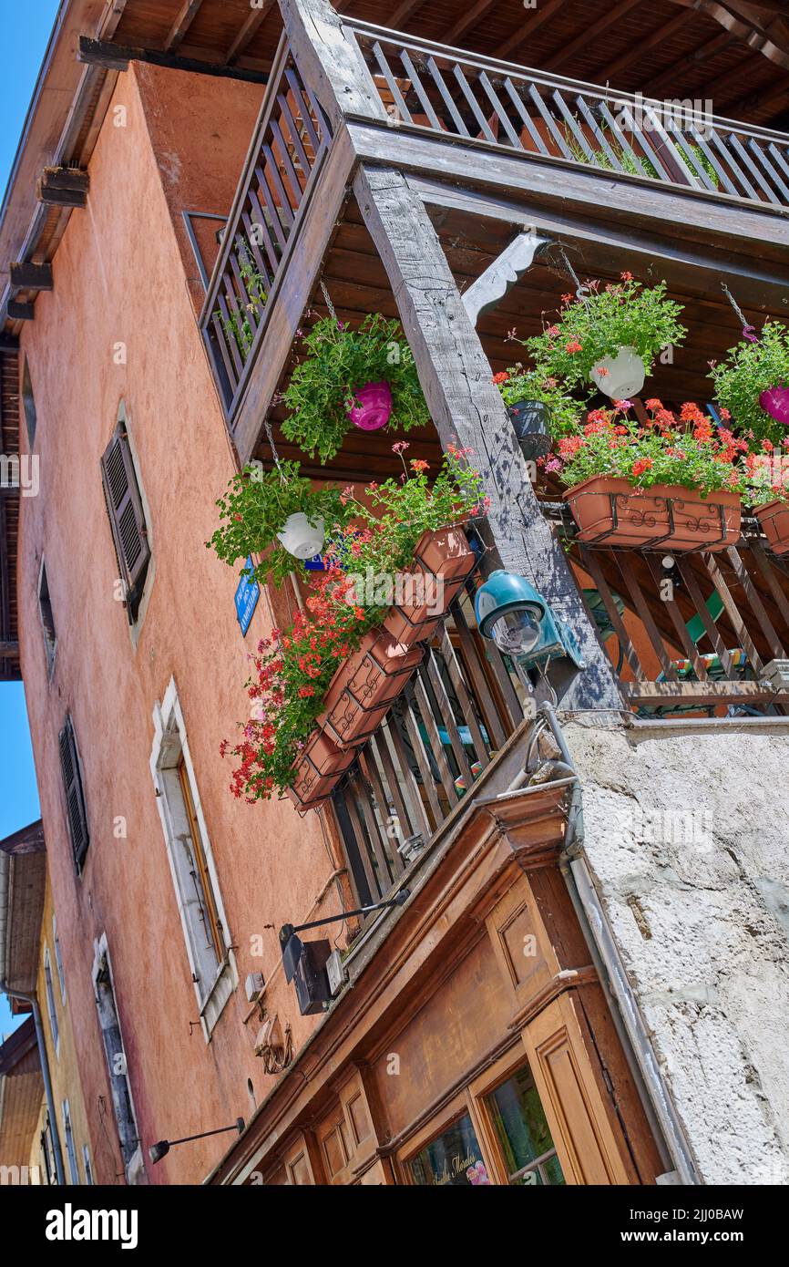 A building in a beautiful old town with flowers growing in the outdoors ...
