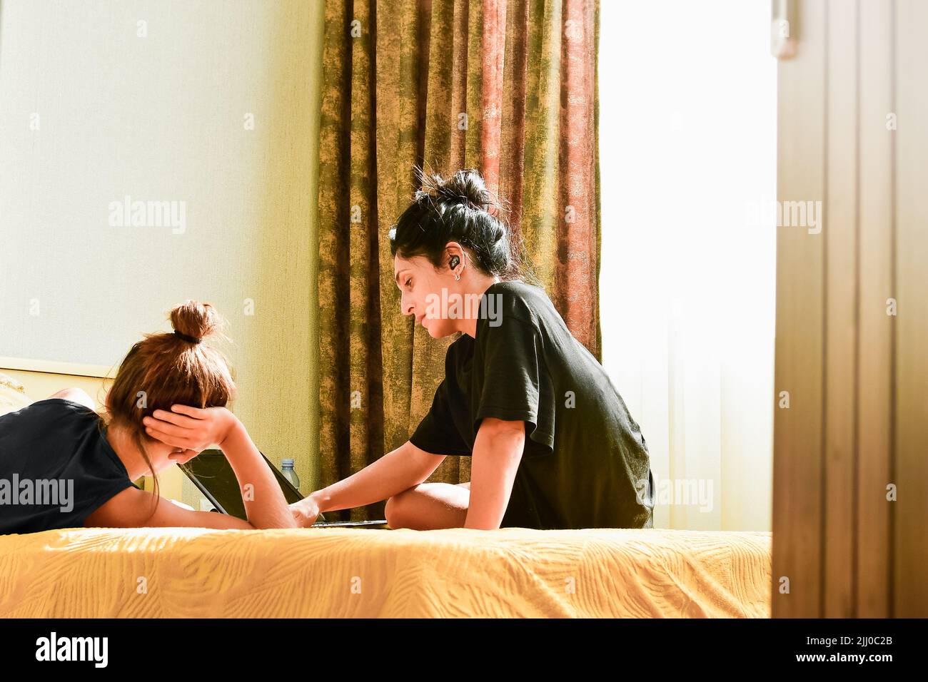 Close up view young caucasian mother type laptop keyword work online ...