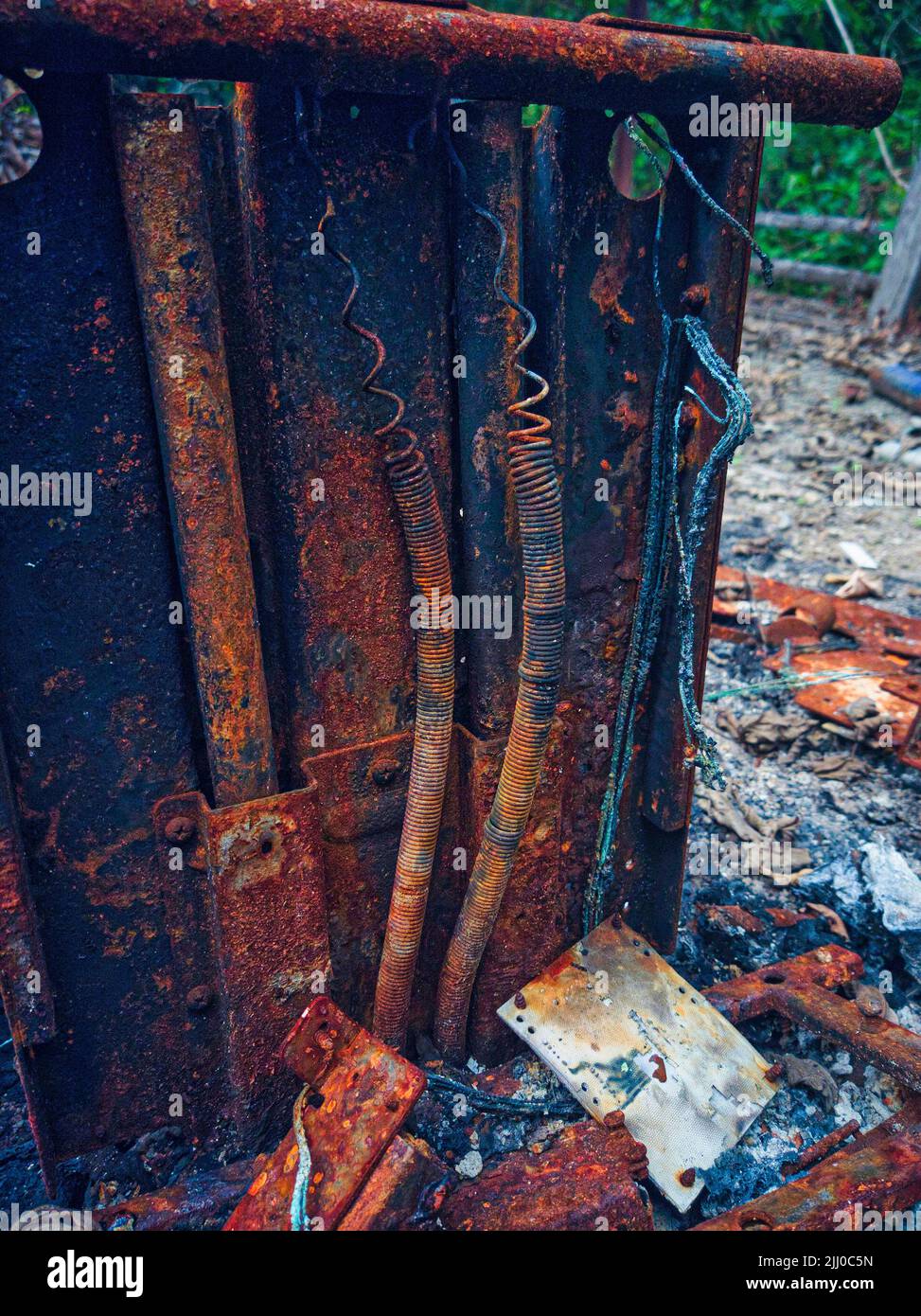 Close up of a rusted and burnt spring coil under the massage chair ...
