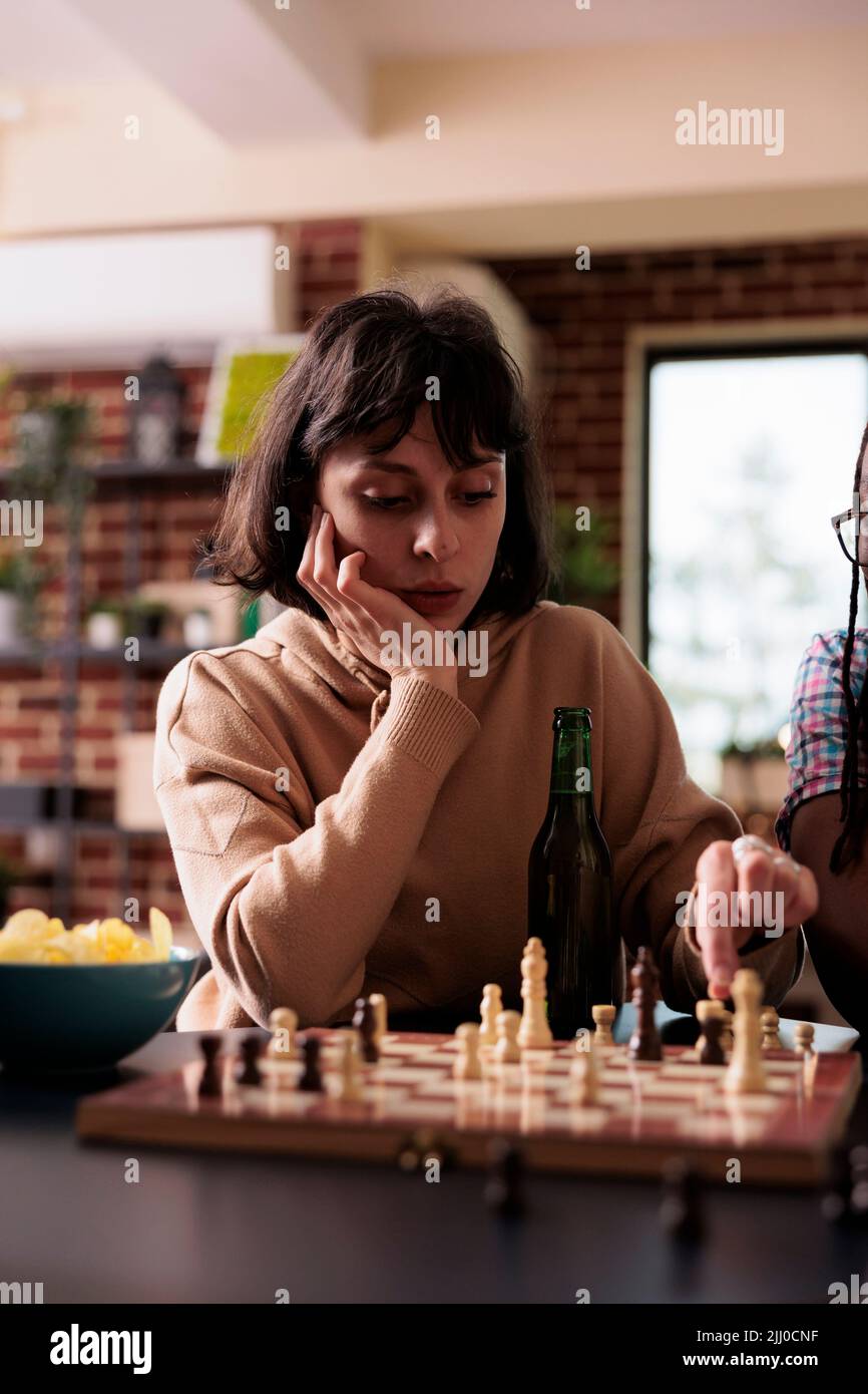 Woman moving piece on chessboard hi-res stock photography and images ...