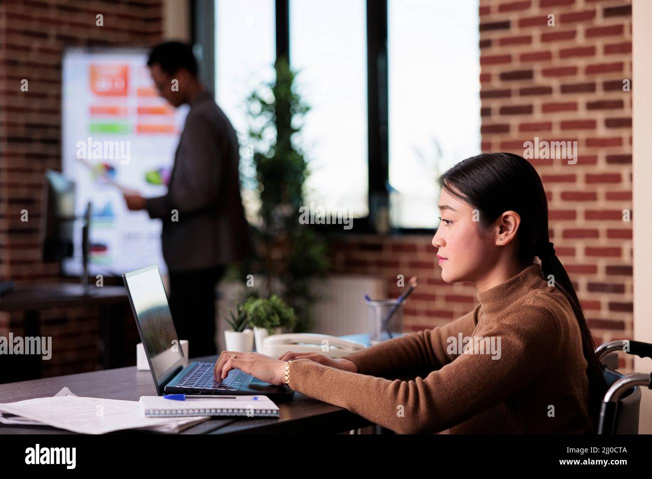 Startup entrepreneur with chronic disability working on laptop to plan ...