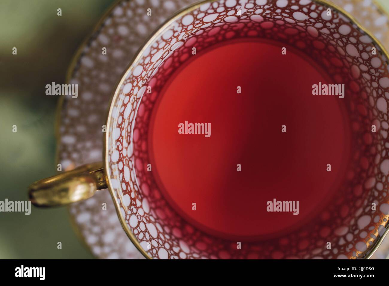 top down shot of pink tea in light pink and gold vintage teacup Stock ...