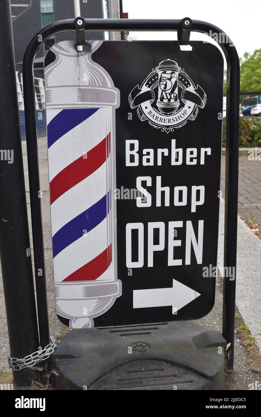 Sign for a barber shop with the traditional red, white, and blue barber ...