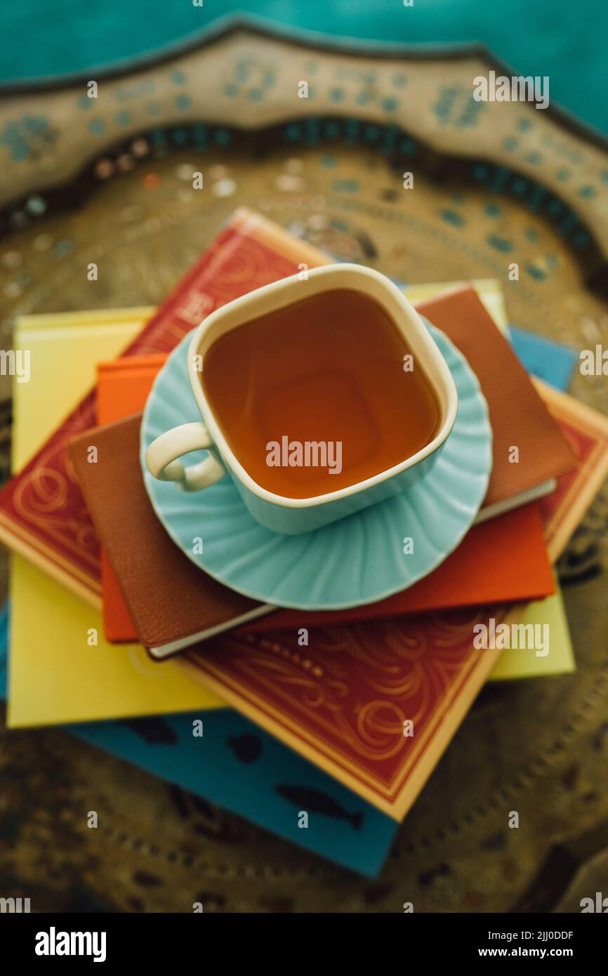 teal teacup on stack of books Stock Photo - Alamy