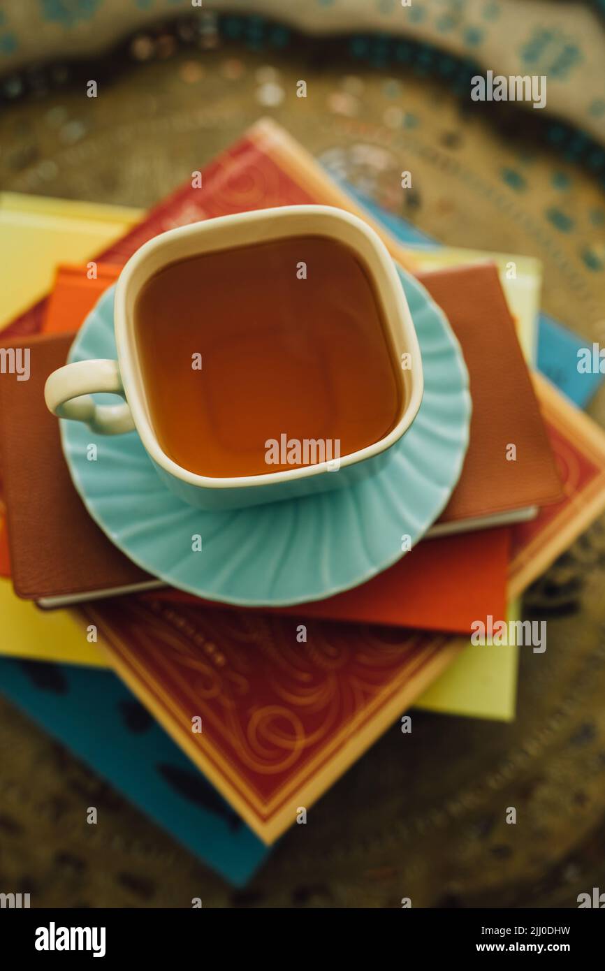 teal teacup on stack of books Stock Photo - Alamy