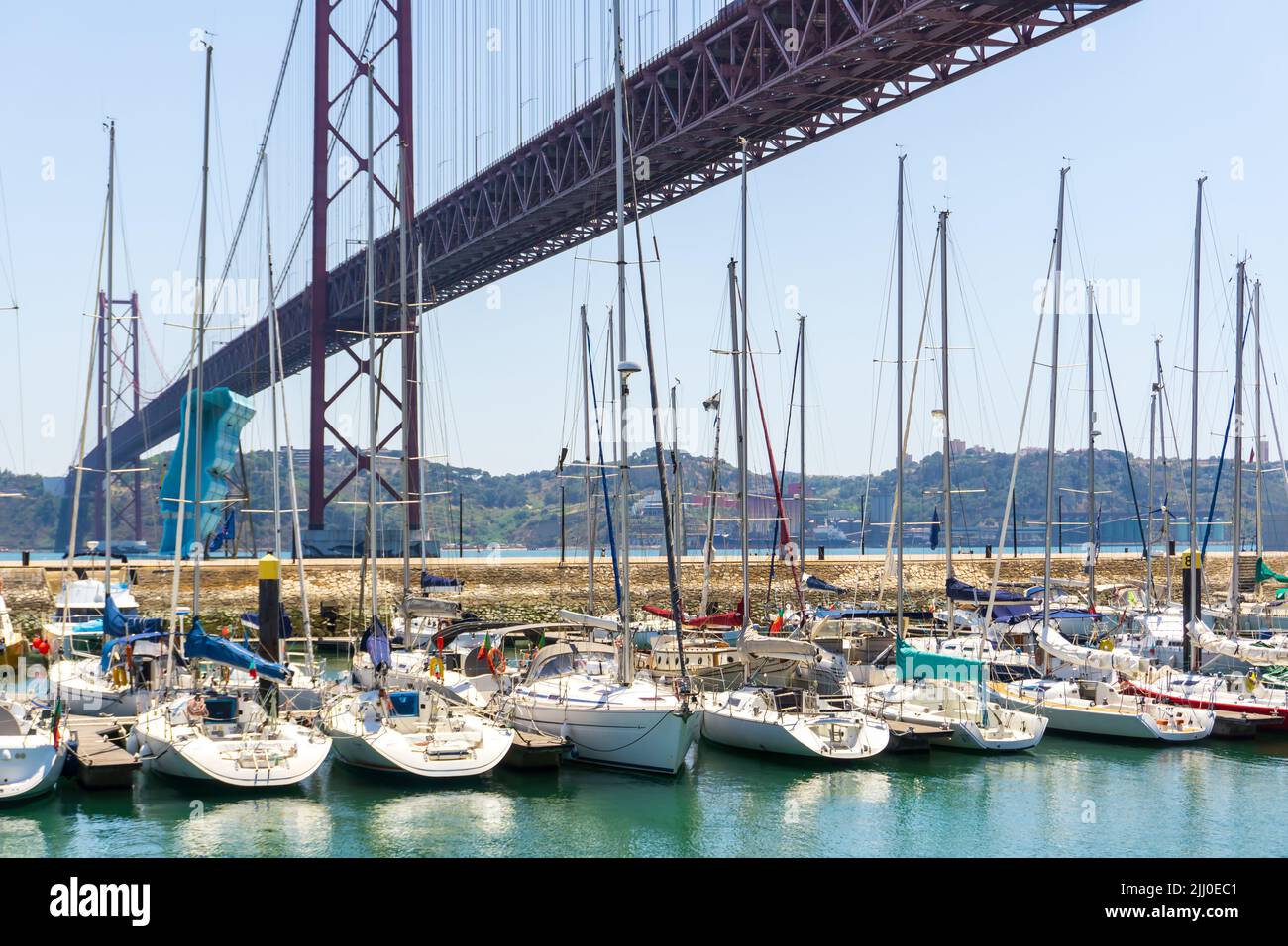 Berth with yachts under the Lisbon bridge April 25 Stock Photo - Alamy