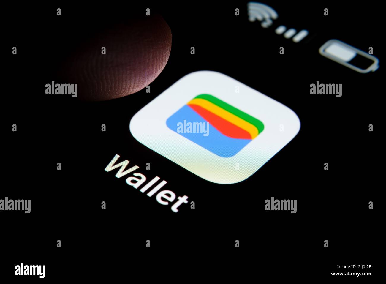 New Google Wallet app seen on the screen of smartphone and finger tip ...