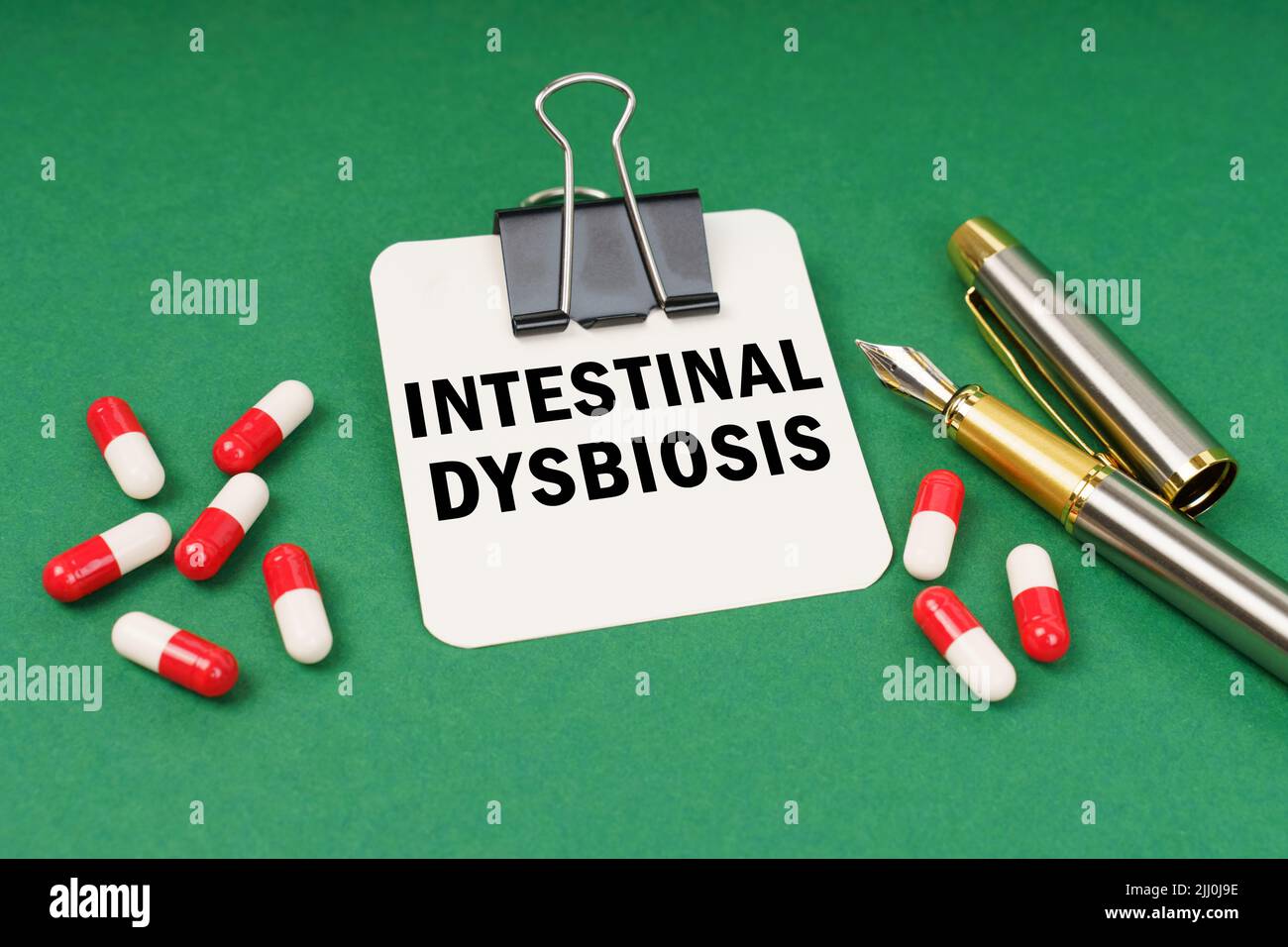 Medical concept. On the green surface of the tablet, a pen and a ...