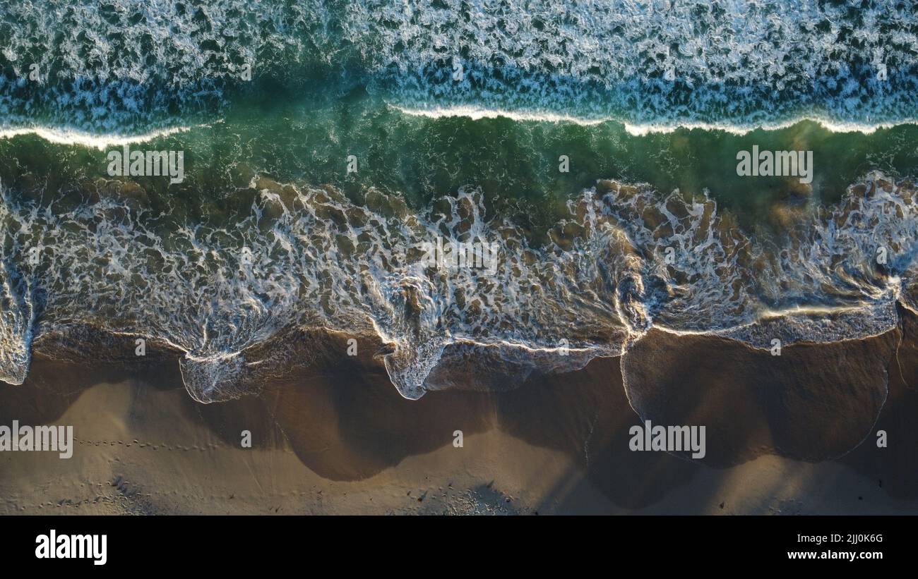 A top view of waves on the beach during summer Stock Photo - Alamy