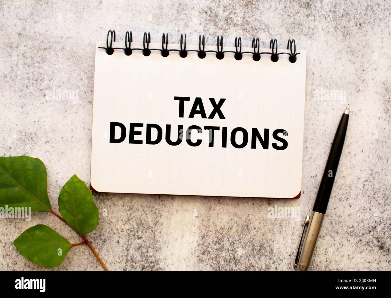 white paper with text Tax Deductions on a yellow background with ...