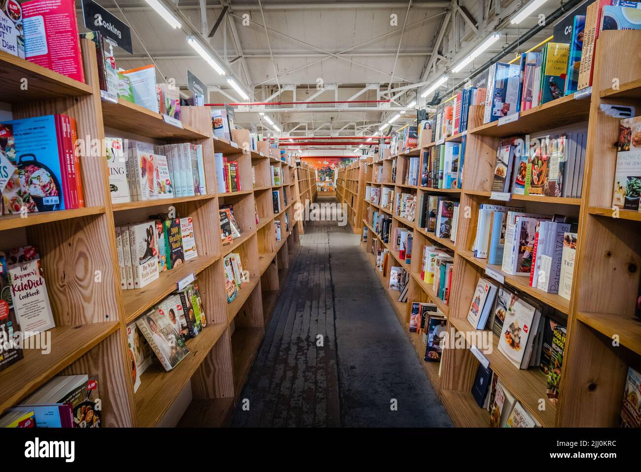 short bookshelves on both sides of an aisle inside an unfurnished ...