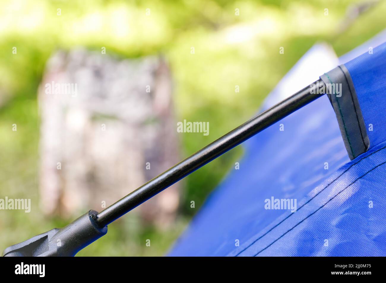 Defocus closeup blue tourist tent standing on green nature background ...