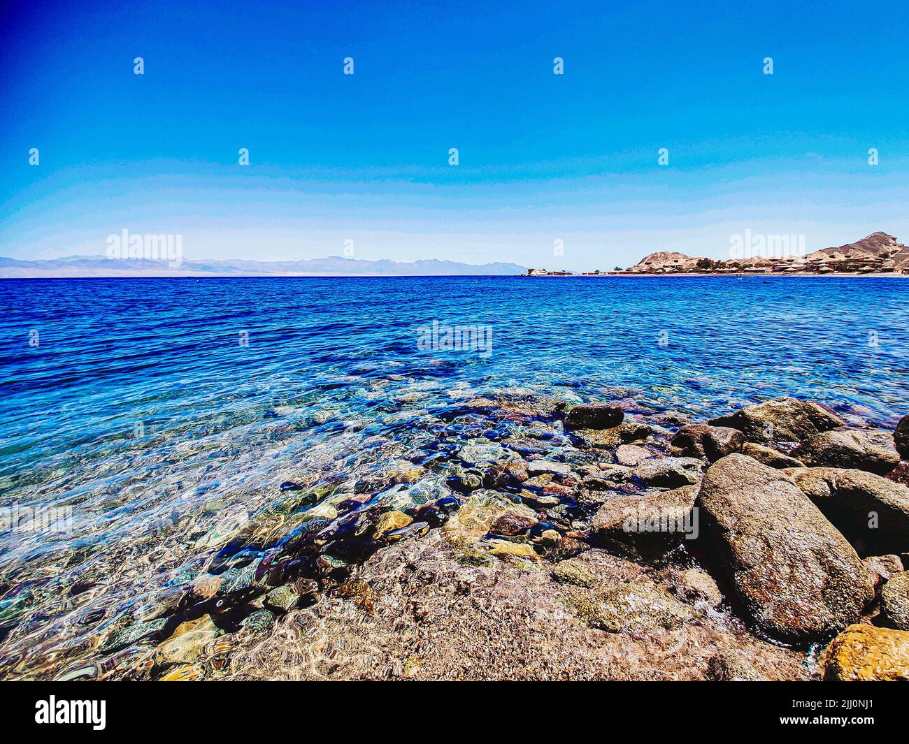 Rock and stones on the seashore on one of the beaches in Ras Shitan ...