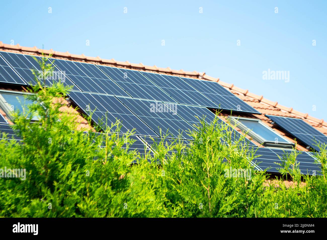 House roof with photovoltaic modules. Historic farm house with modern ...