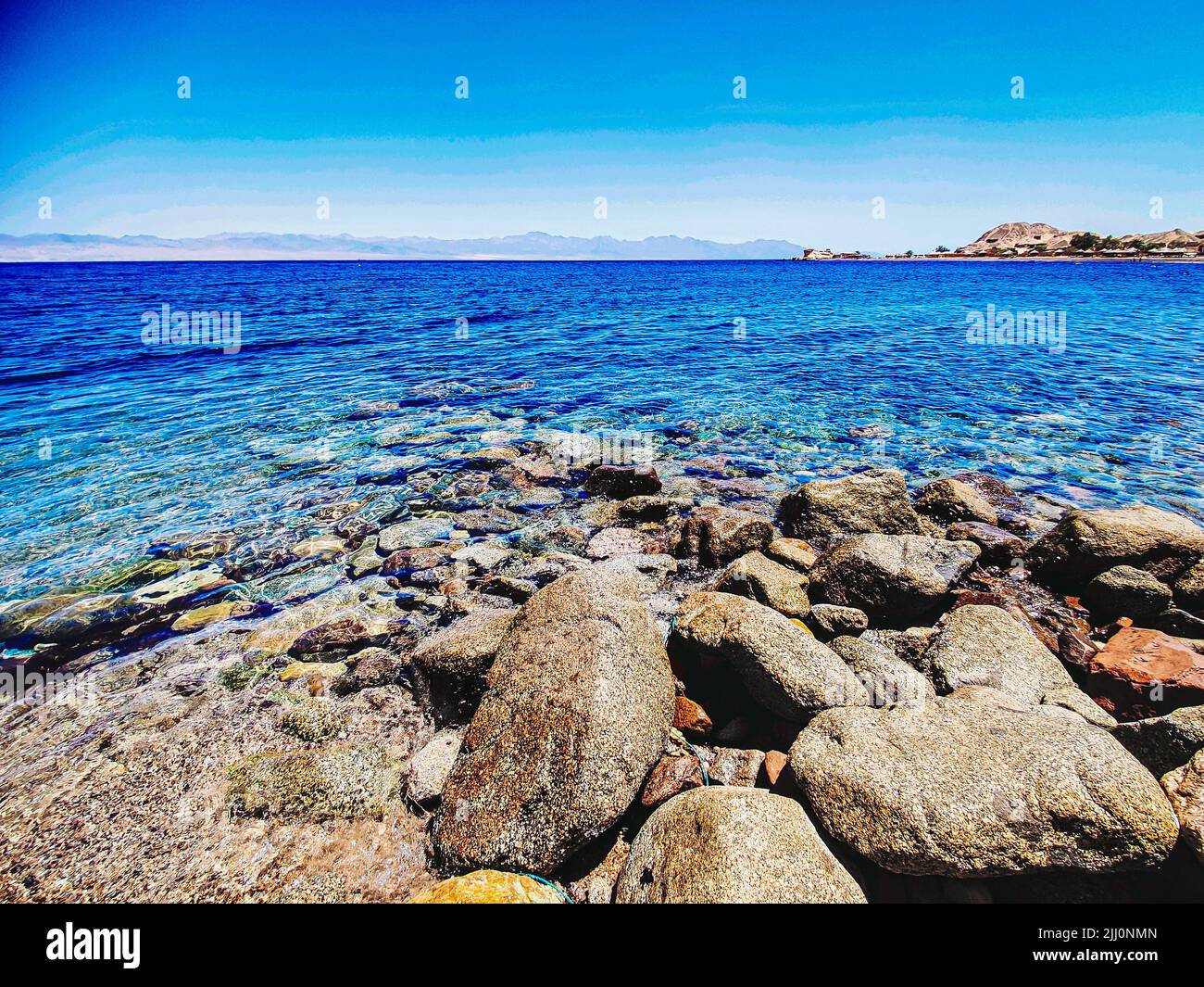 Rock and stones on the seashore on one of the beaches in Ras Shitan ...