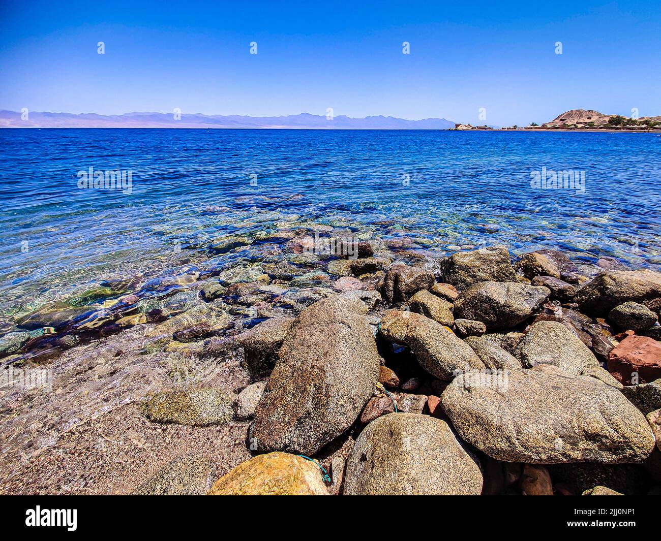 Rock and stones on the seashore on one of the beaches in Ras Shitan ...
