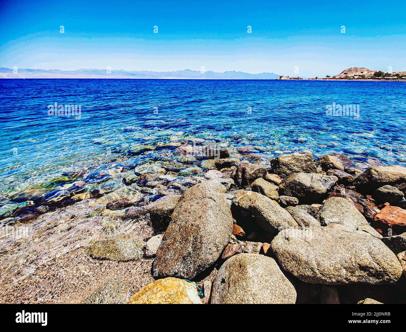 Rock and stones on the seashore on one of the beaches in Ras Shitan ...