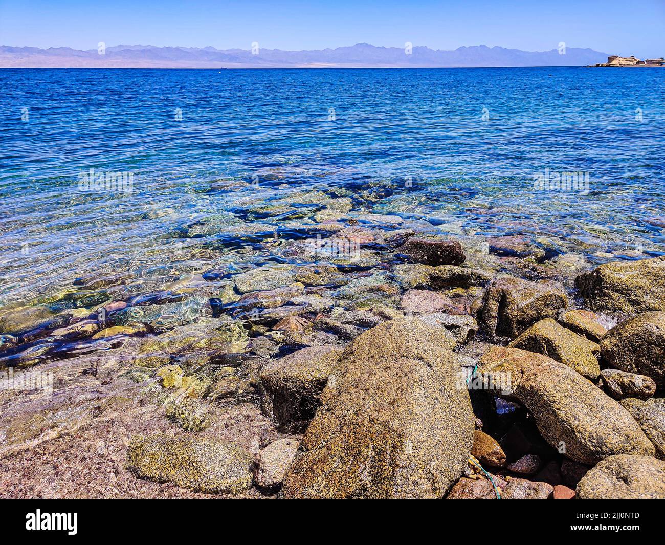 Rock and stones on the seashore on one of the beaches in Ras Shitan ...
