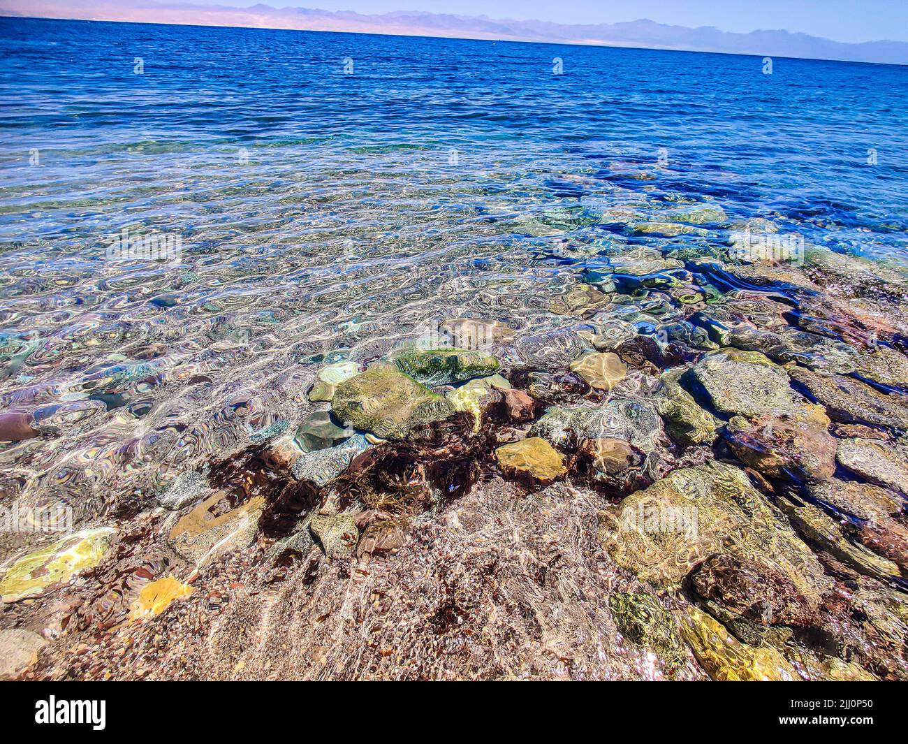 Rock and stones on the seashore on one of the beaches in Ras Shitan ...