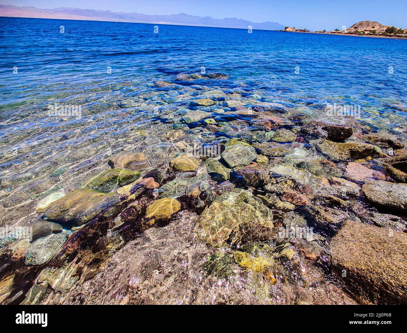 Rock and stones on the seashore on one of the beaches in Ras Shitan ...