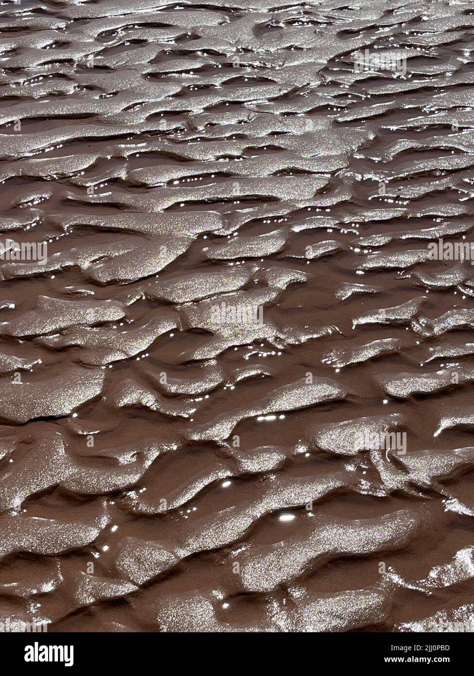 The ripple pattern on beach sand, vertical Stock Photo - Alamy