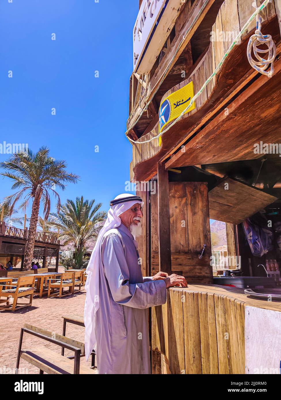 Bedouin Old Shiek with white beard on rustic bar waiting for his coffee ...