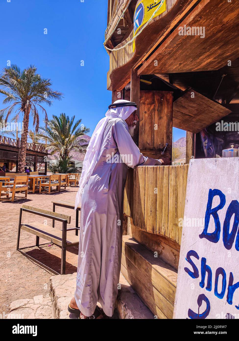 Bedouin Old Shiek with white beard on rustic bar waiting for his coffee ...