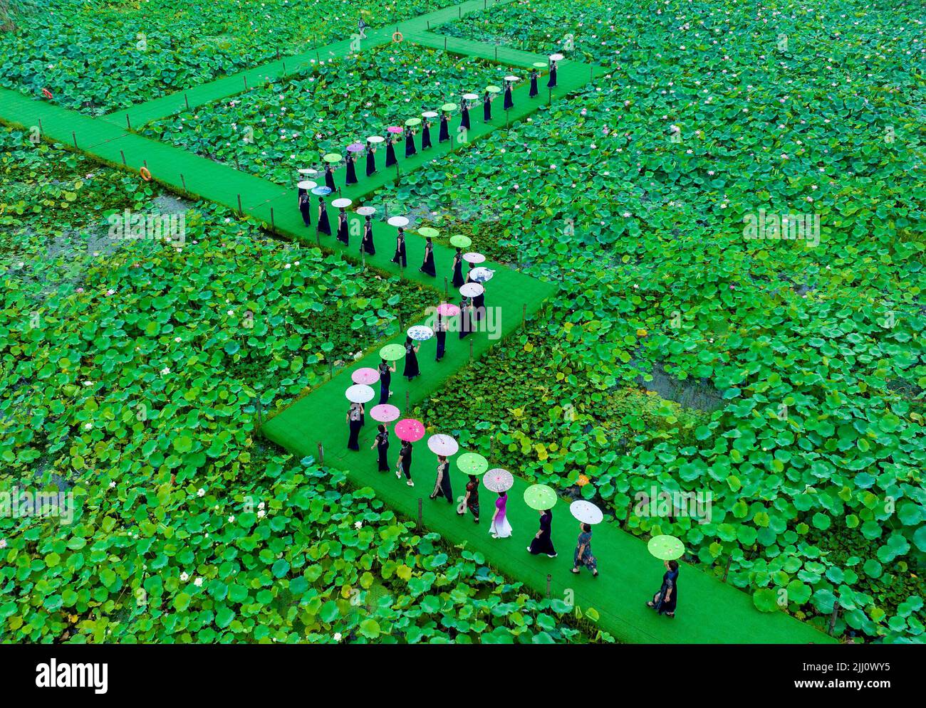SUQIAN, CHINA - JULY 21, 2022 - Women in cheongsam walk along the Plank ...