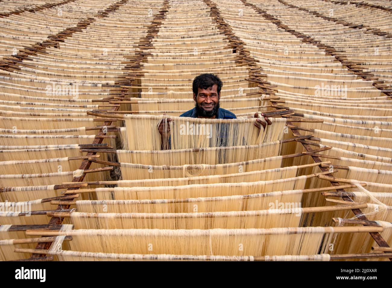 Workers making semai, traditional rice vermicelli noodles in Bangladesh ...
