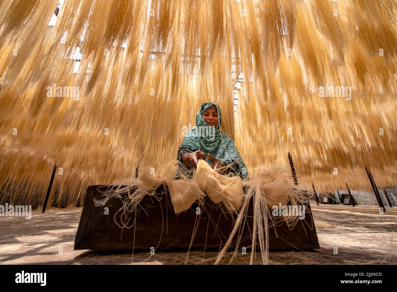 Workers making semai, traditional rice vermicelli noodles in Bangladesh ...