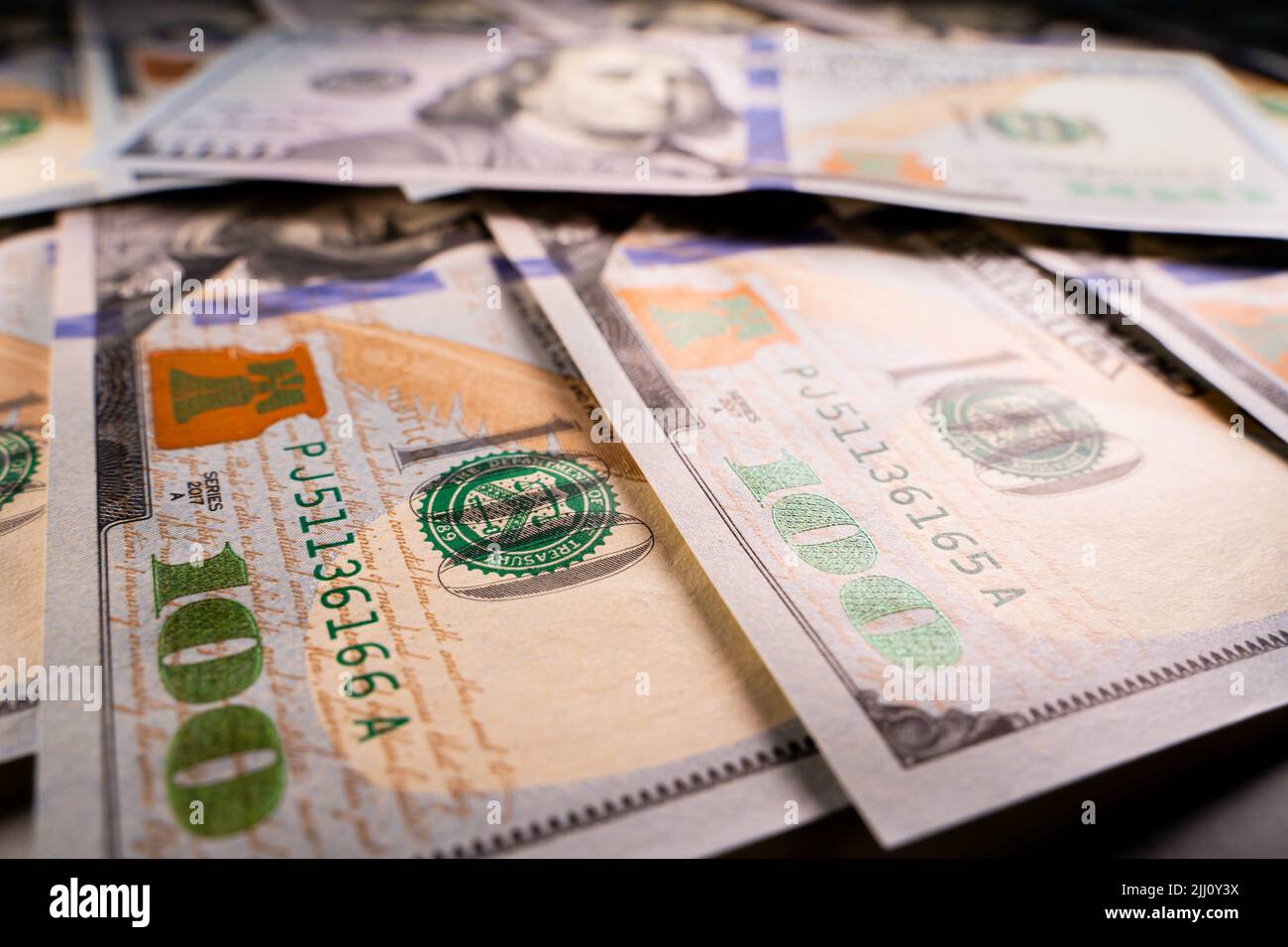 Close-up beautiful clean new one hundred dollar bill lies on other one ...