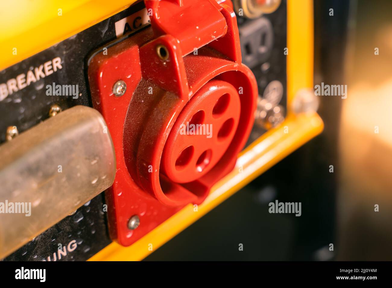 Red three-pin power socket on the gas generator housing close-up Stock ...